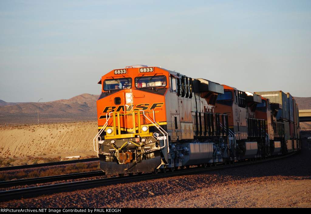 The Sun Glows Off BNSF 6833's BNSF Swoosh Logo as she heads west with the S LPC-SCL Double Stack.